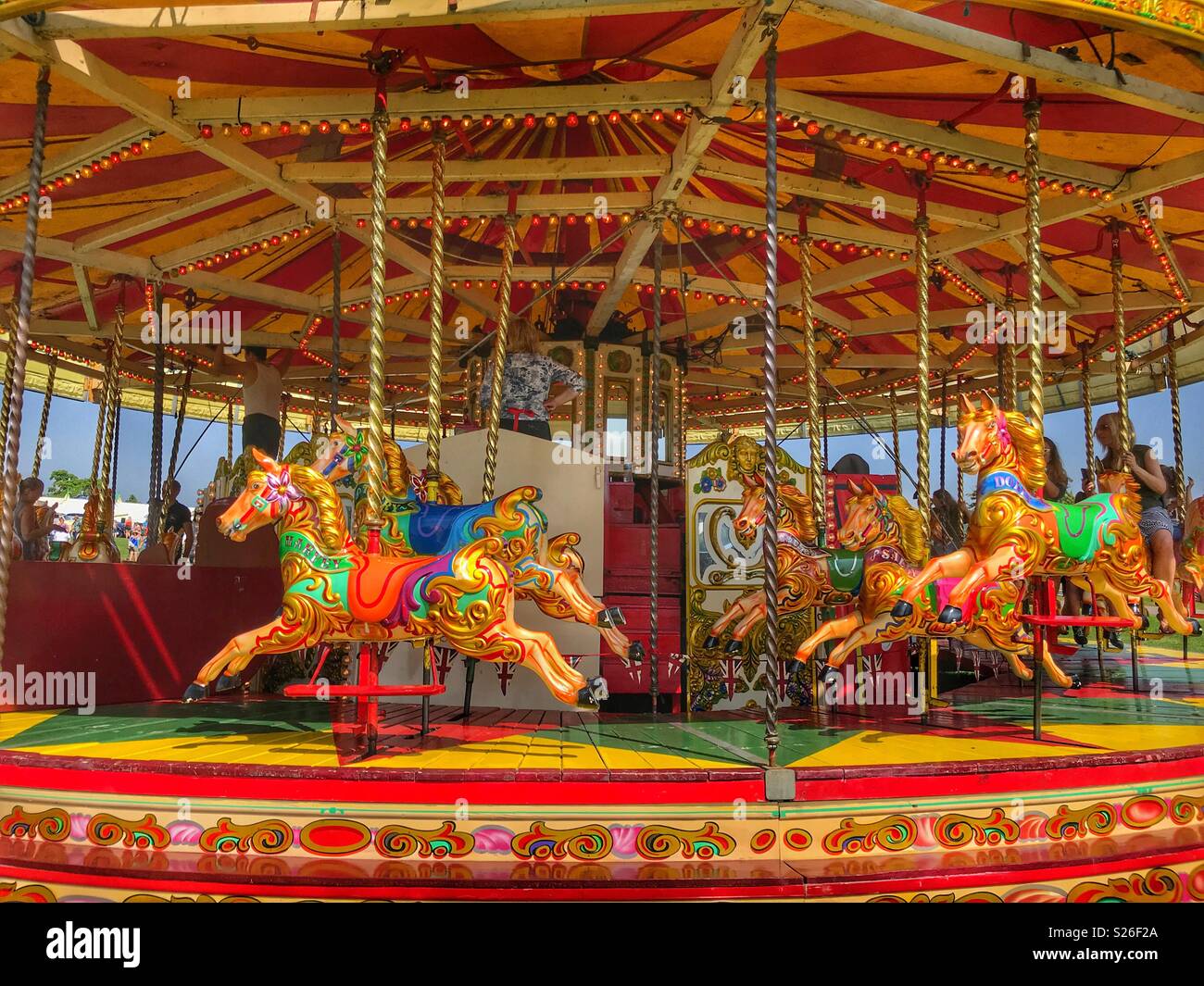 Traditional merry-go-round, carousel with colourful horses, Sherborne ...