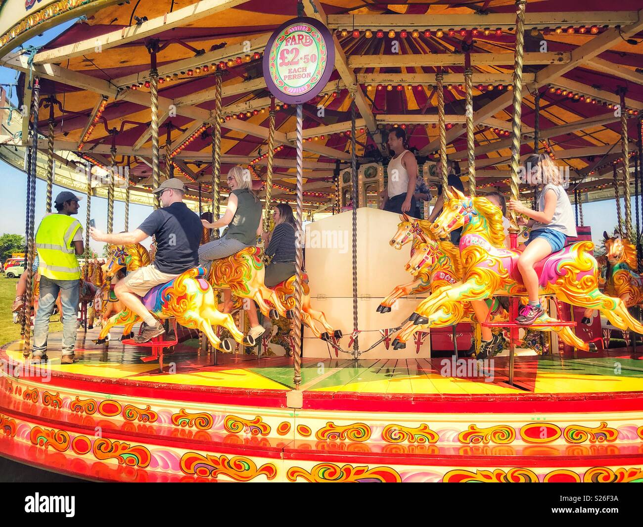 Traditional merry-go-round, carousel with colourful horses, Sherborne ...