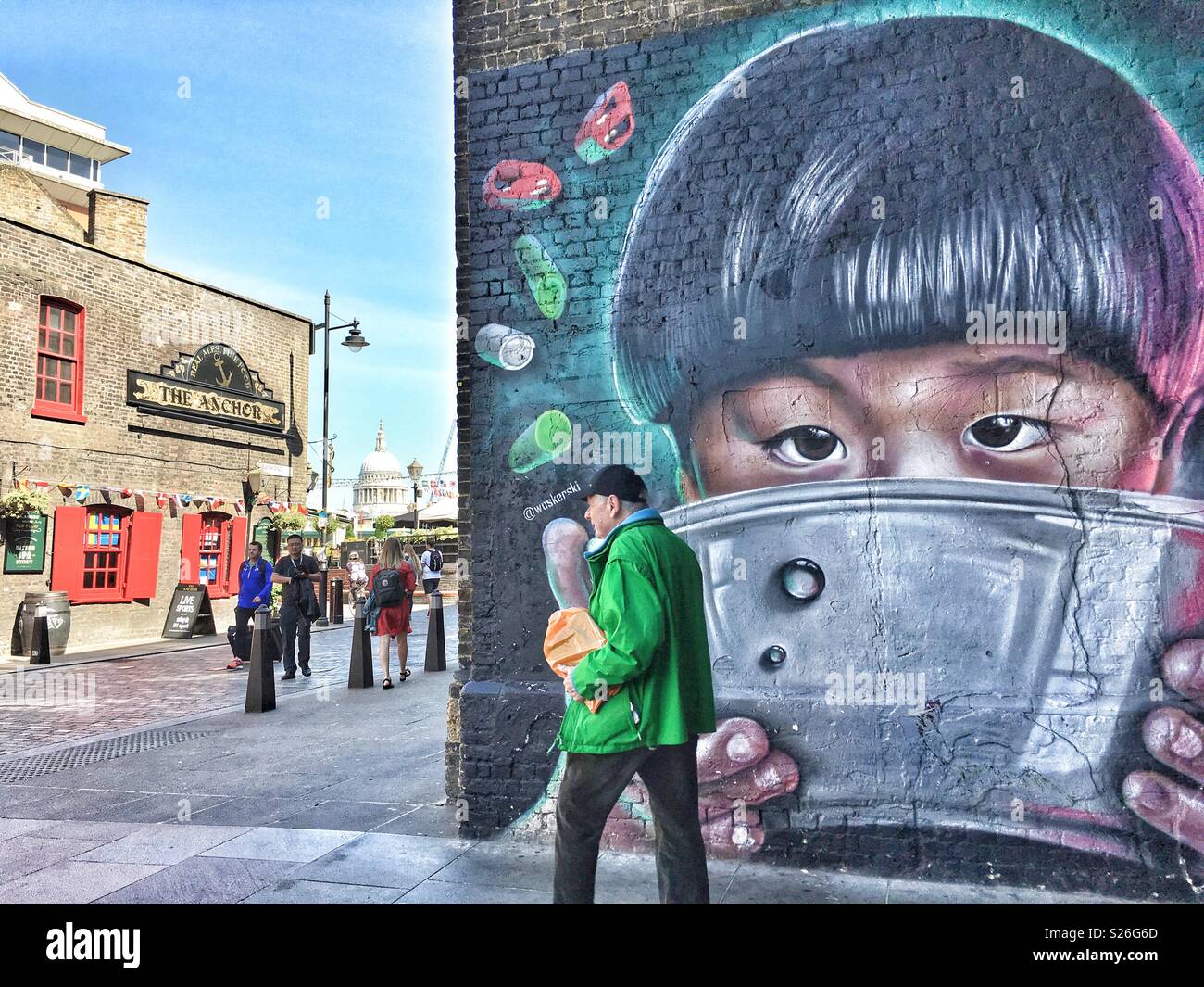 A man walks past a mural outside Wagamama’s restaurant on Clink Street ...
