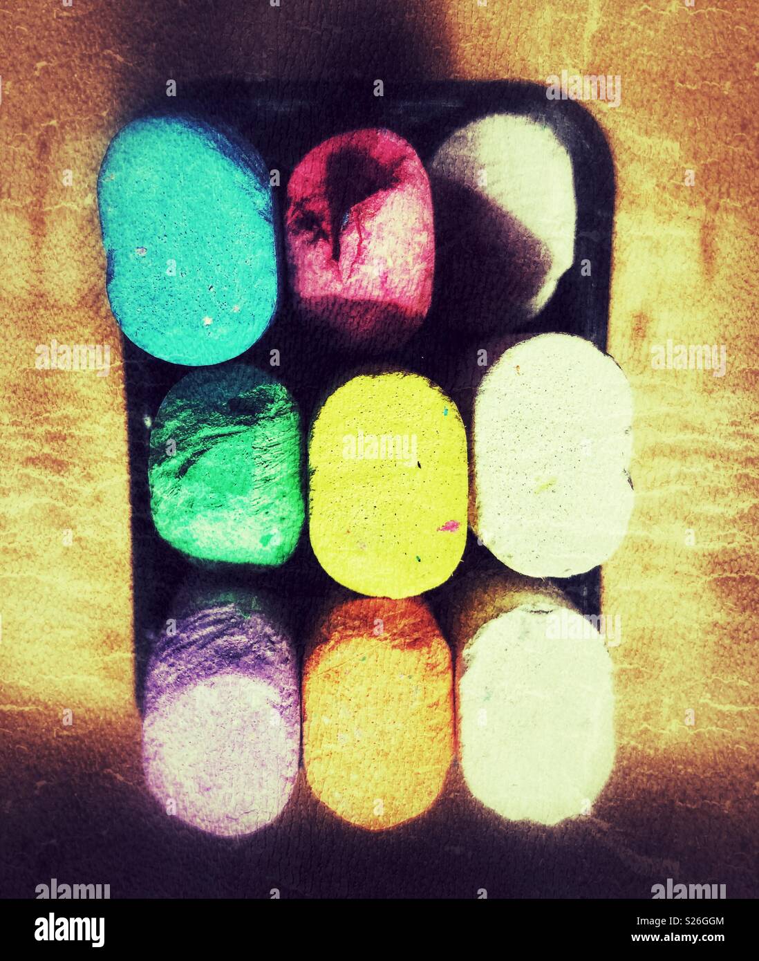 Box of different coloured chalk in a box shot from above using a grunge ...