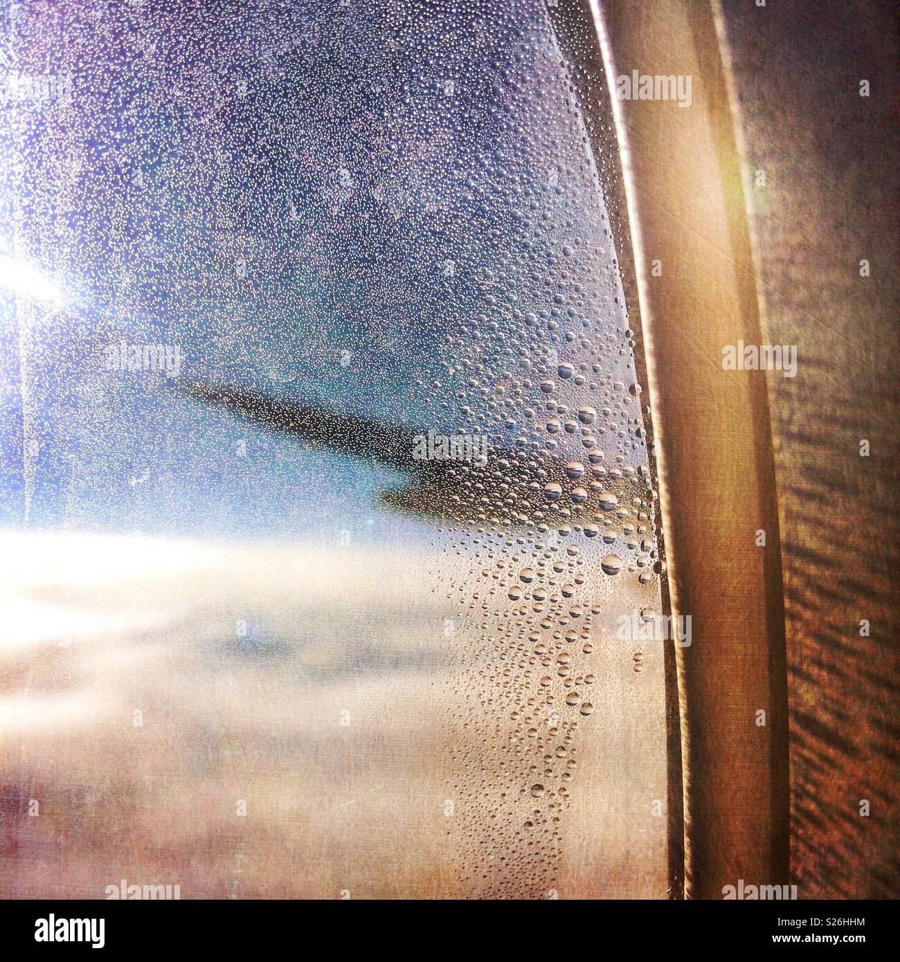 Water drops on an airplane window with the shape of the wing ...