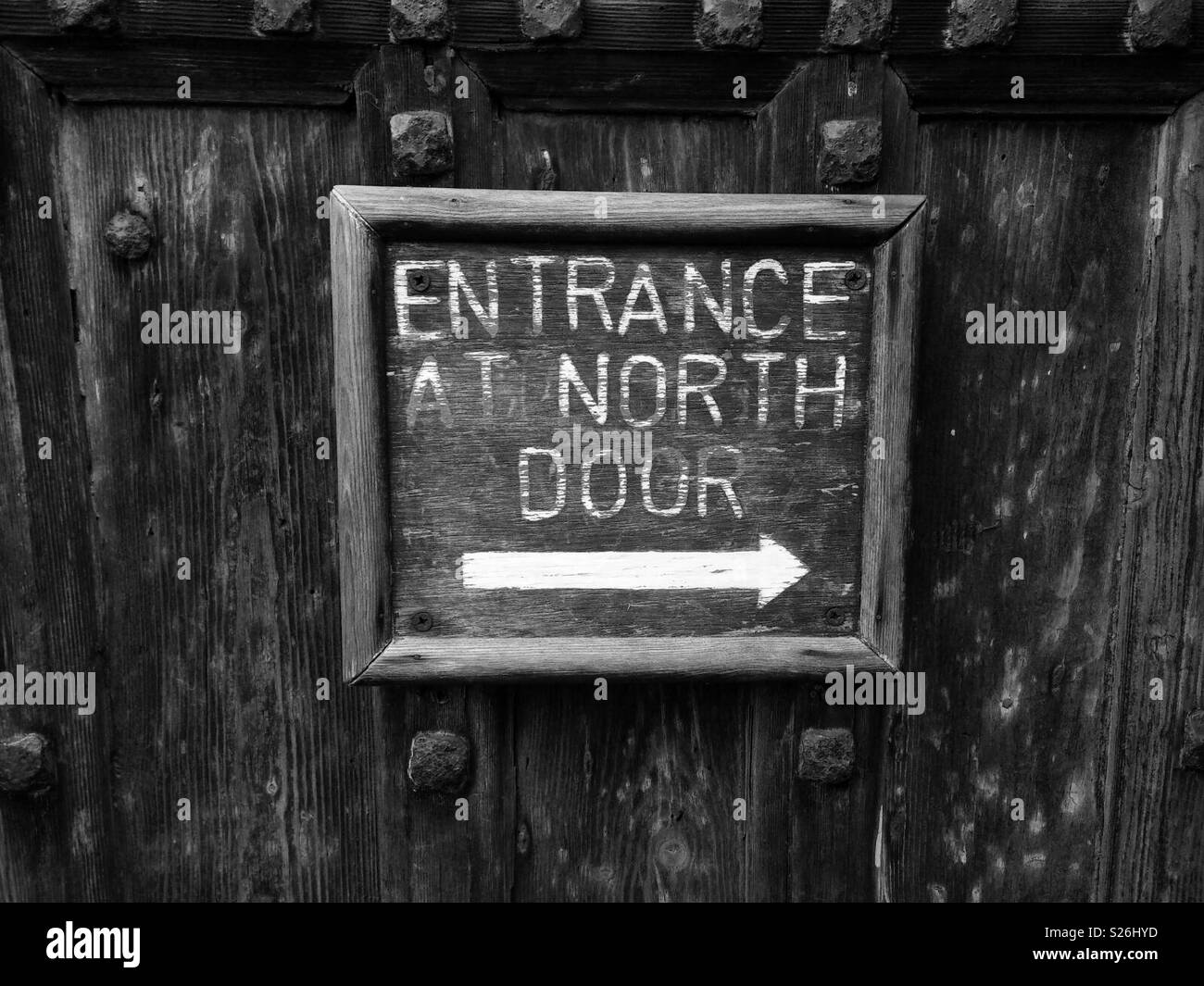 Sign saying entrance at north door in black and white Stock Photo - Alamy