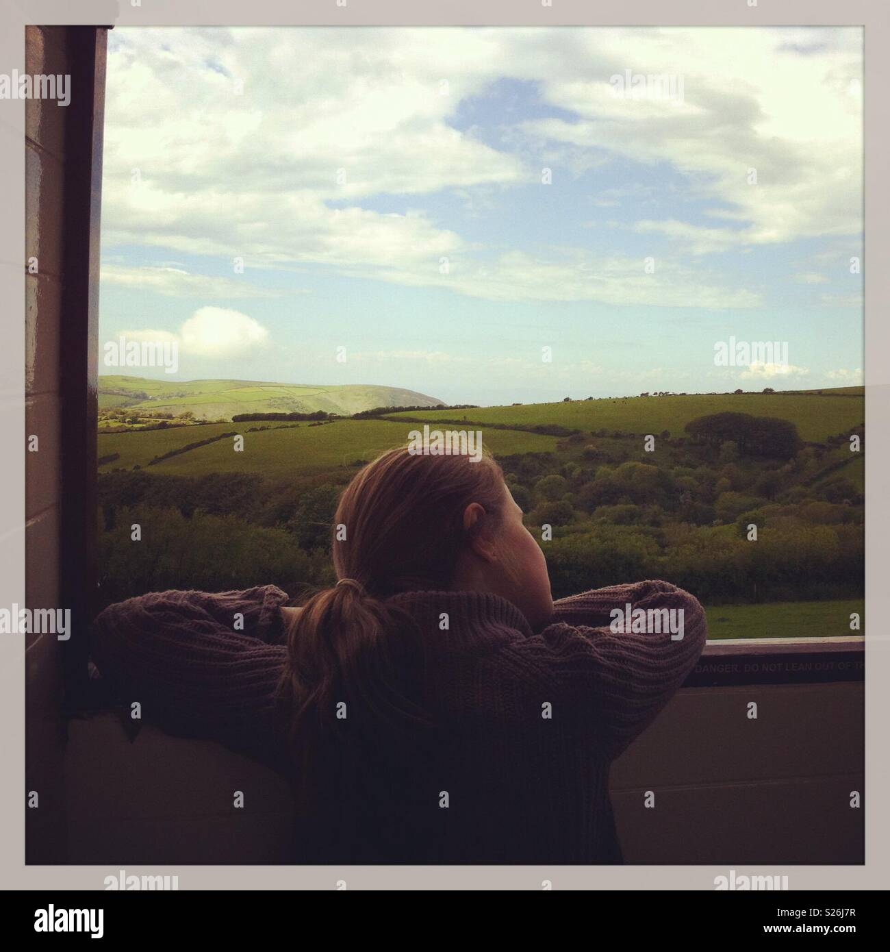 Girl looking out train window hi-res stock photography and images - Alamy