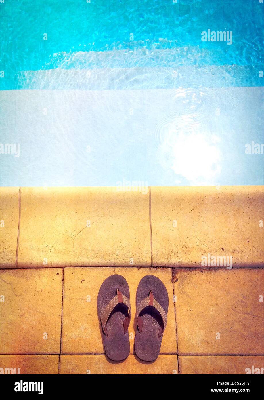 Entering swimming pool. Flat lay picture of a pair of flip-flops on the ...