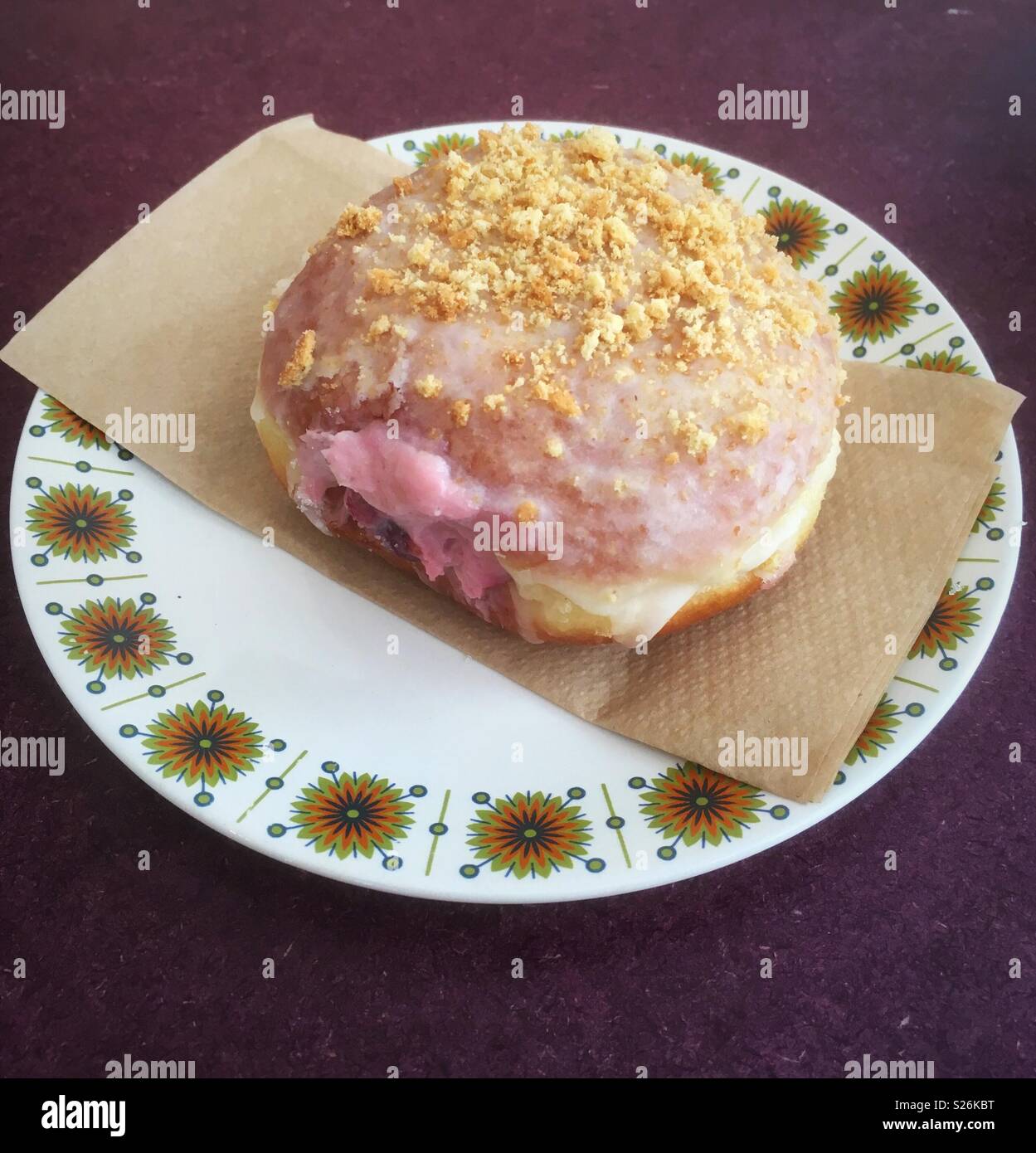 Delicious donut with oozing filling in vintage plate Stock Photo - Alamy