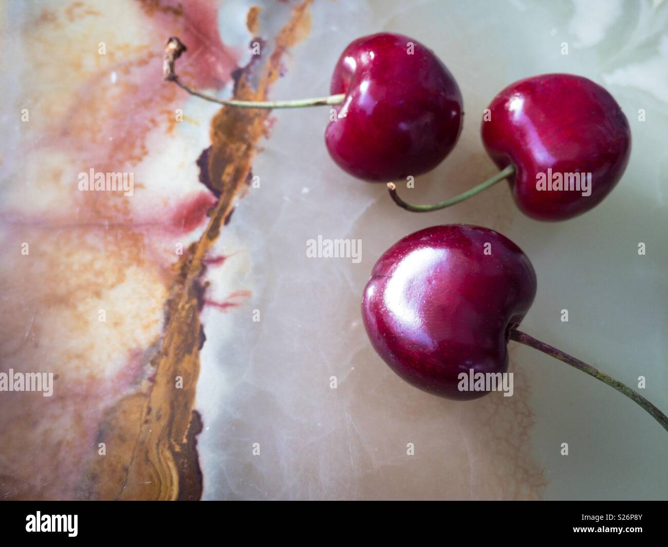 Beautiful red cherries on luxury table Stock Photo - Alamy