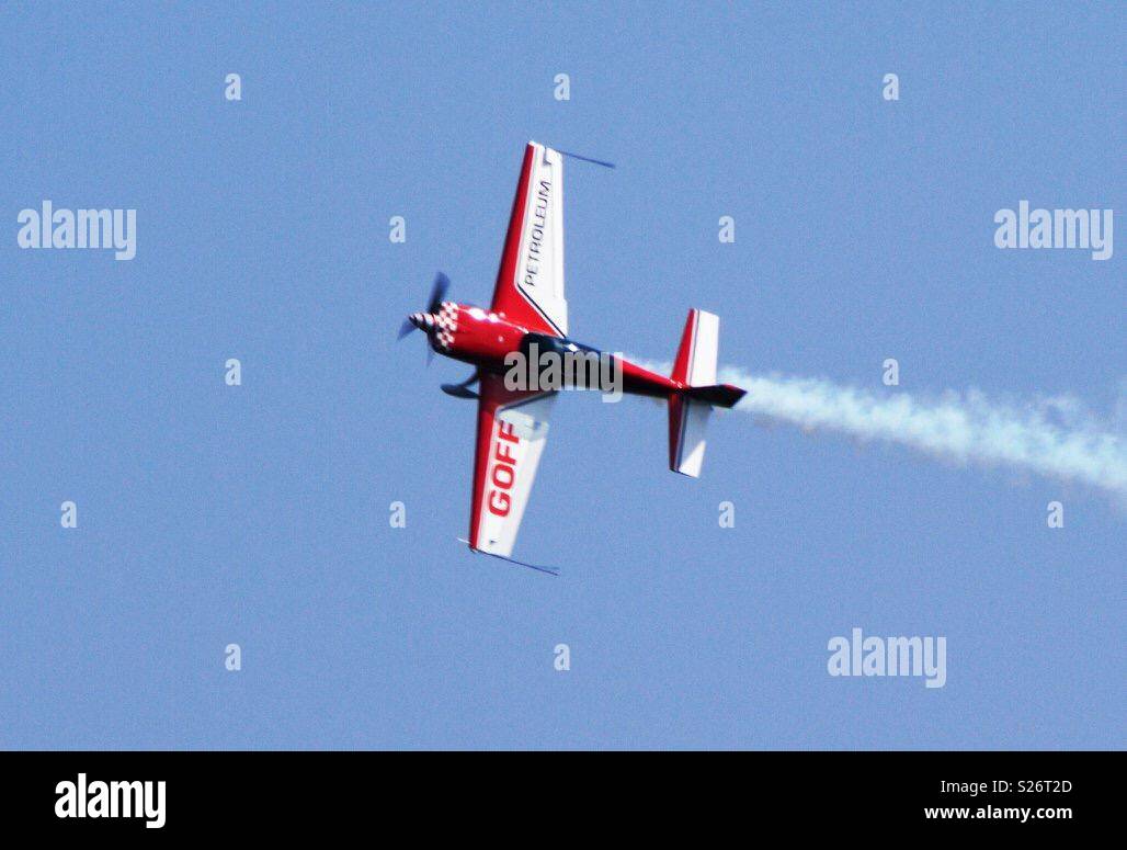 Flying colourful plane Stock Photo - Alamy