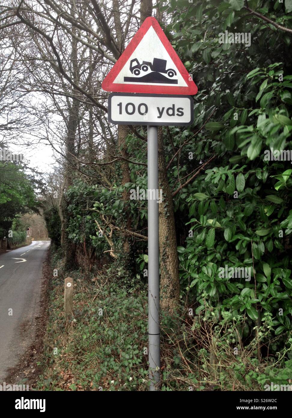 Warning sign for humpback bridge on the road ahead Stock Photo - Alamy
