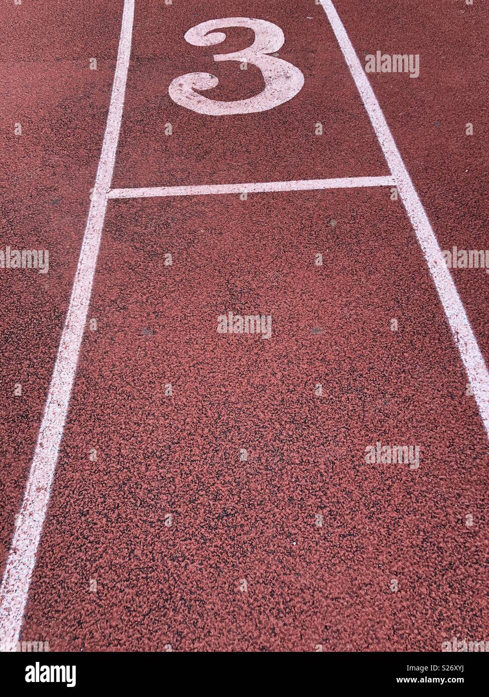 Track 3 on a track an field stadium Stock Photo - Alamy