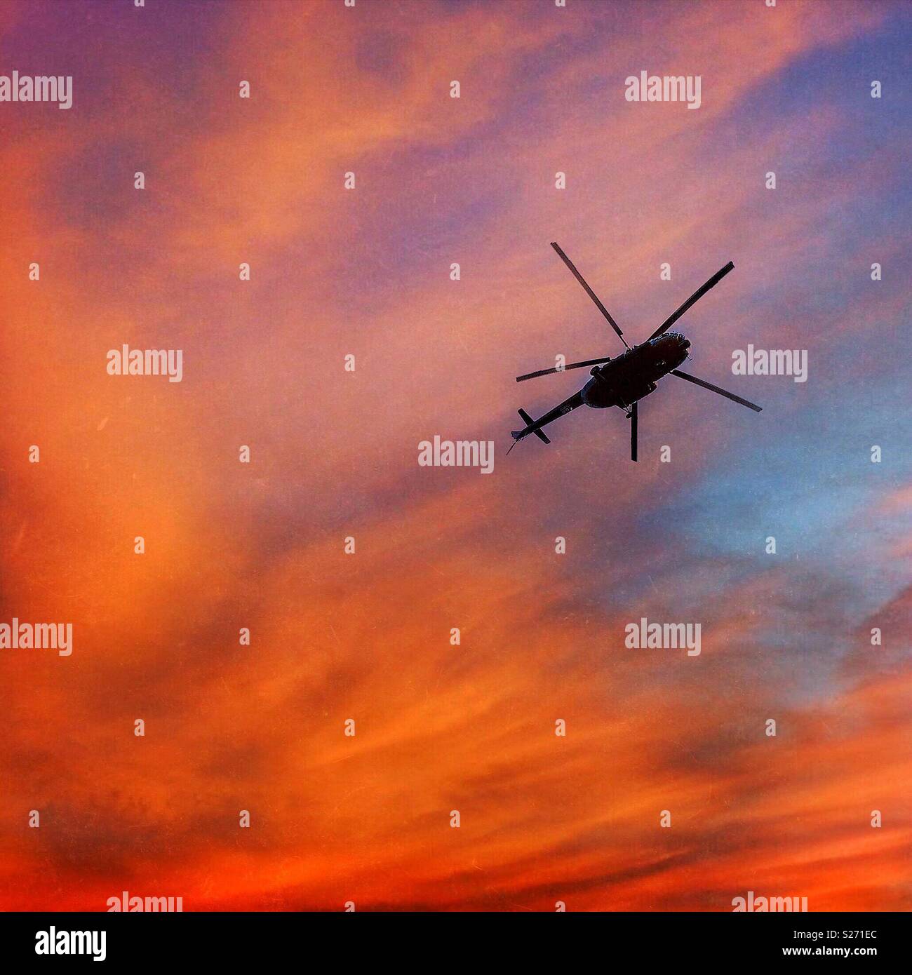 Helicopter in sunset Stock Photo - Alamy