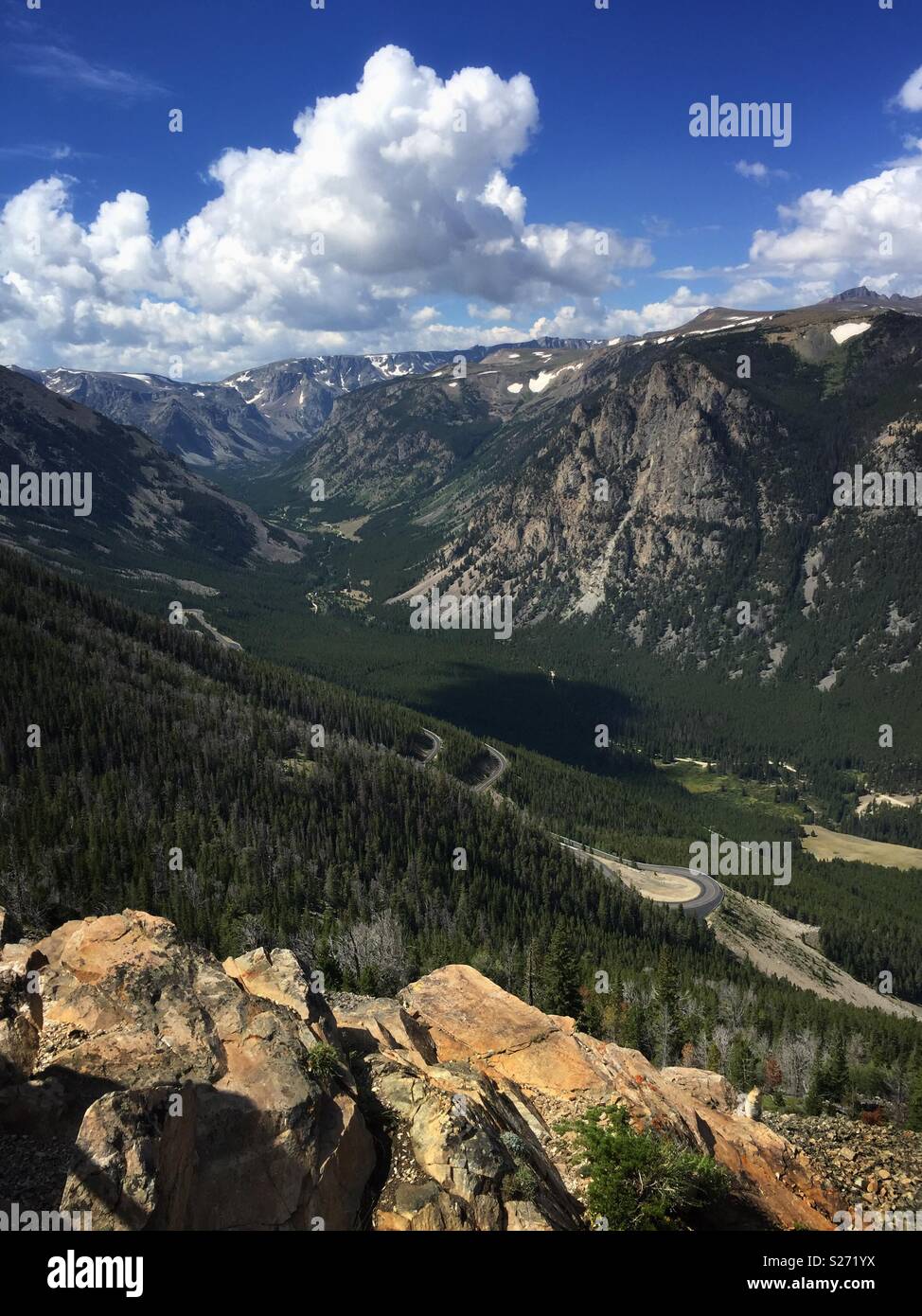 White fluffy clouds in a deep blue sky over Beartooth Pass in ...
