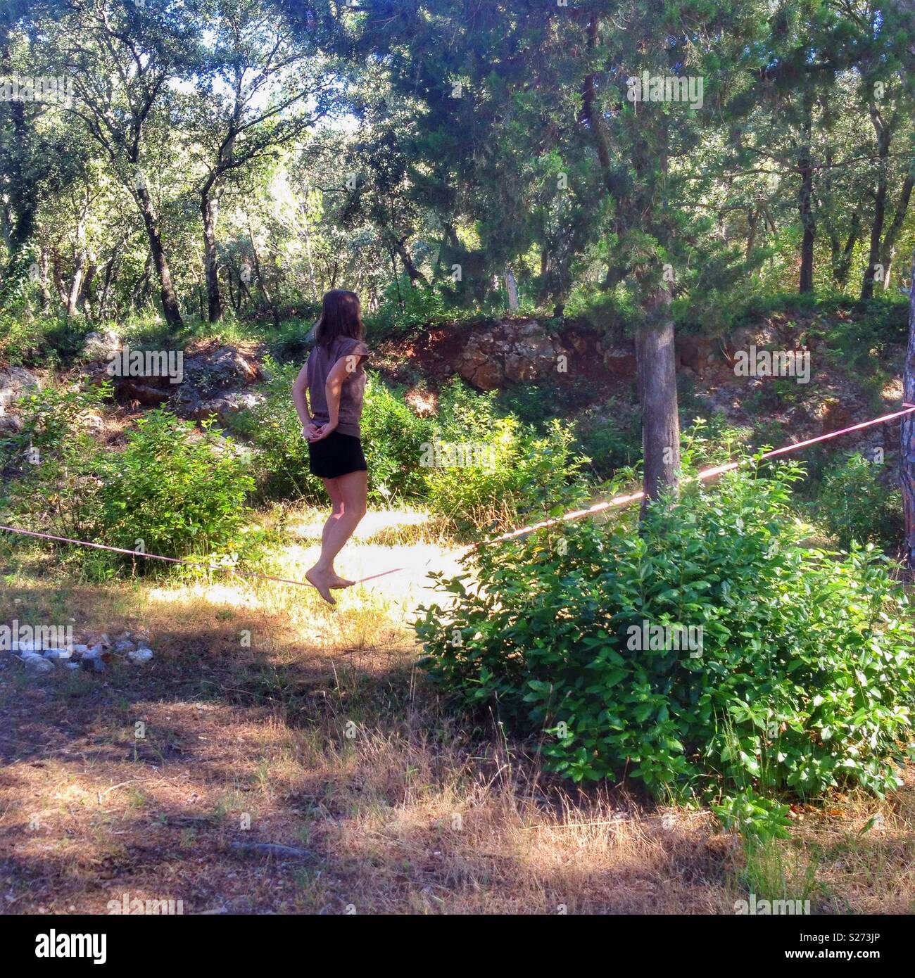 Young woman on a slackline Stock Photo - Alamy