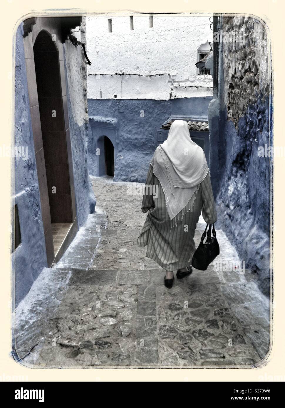 Lady descending stairs in Chefchaouen, Morocco wearing traditional ...