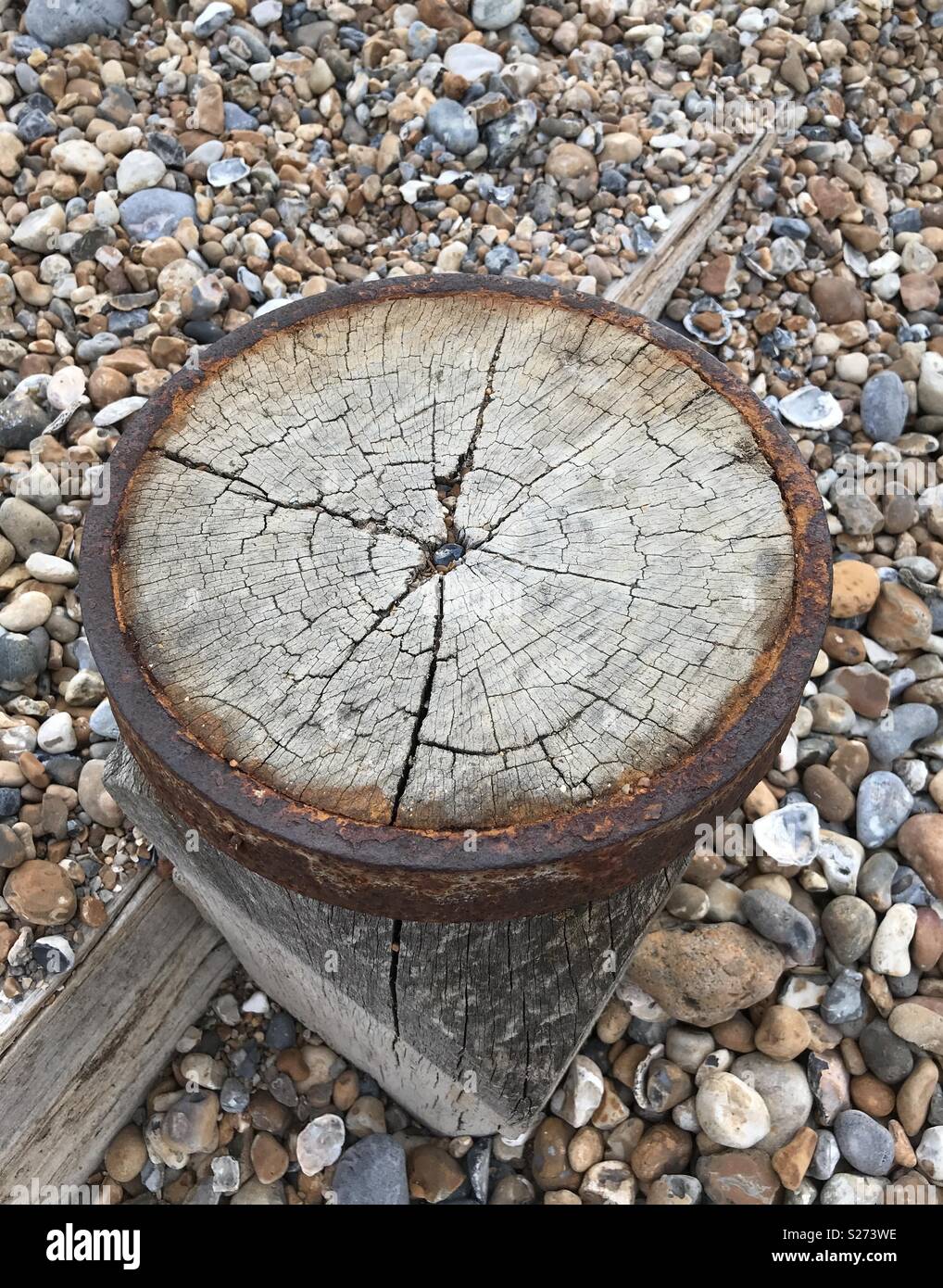 Beach groom post with rusted iron band Stock Photo - Alamy