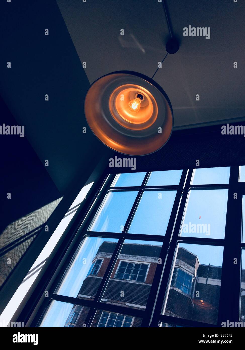 Light on ceiling and angled view out of window Stock Photo - Alamy