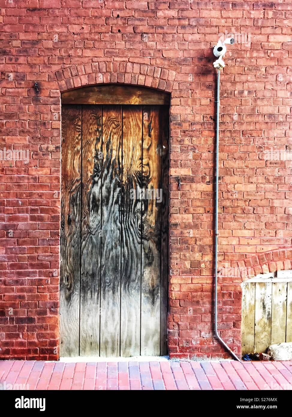 Old brick wall and wooden door in an old alley way Stock Photo - Alamy