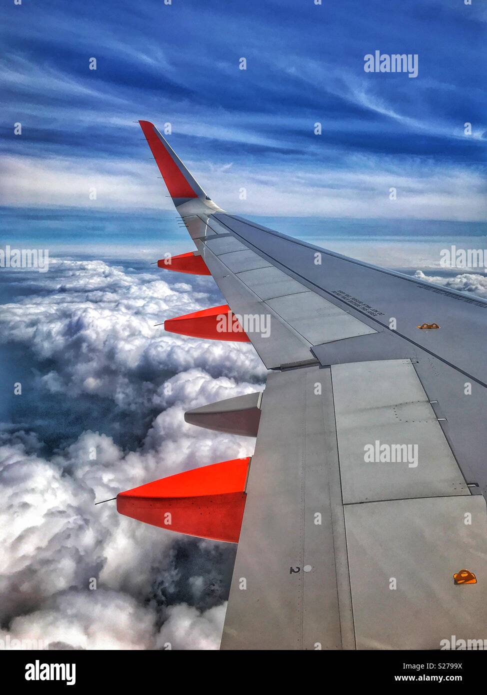 A window view out of an EasyJet aircraft cruising above the clouds. It ...