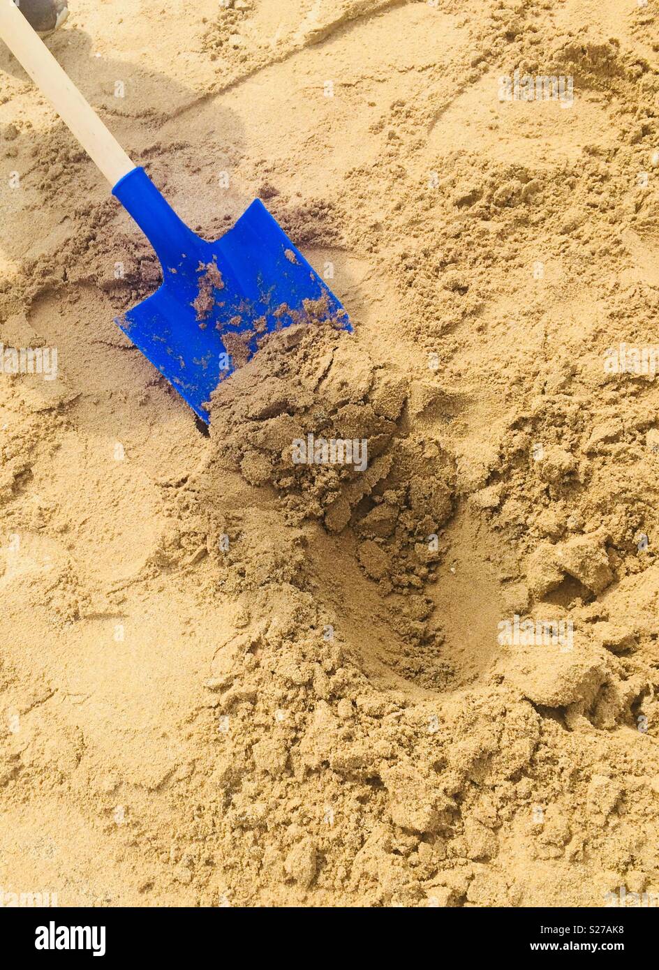 Blue spade on beach Stock Photo - Alamy