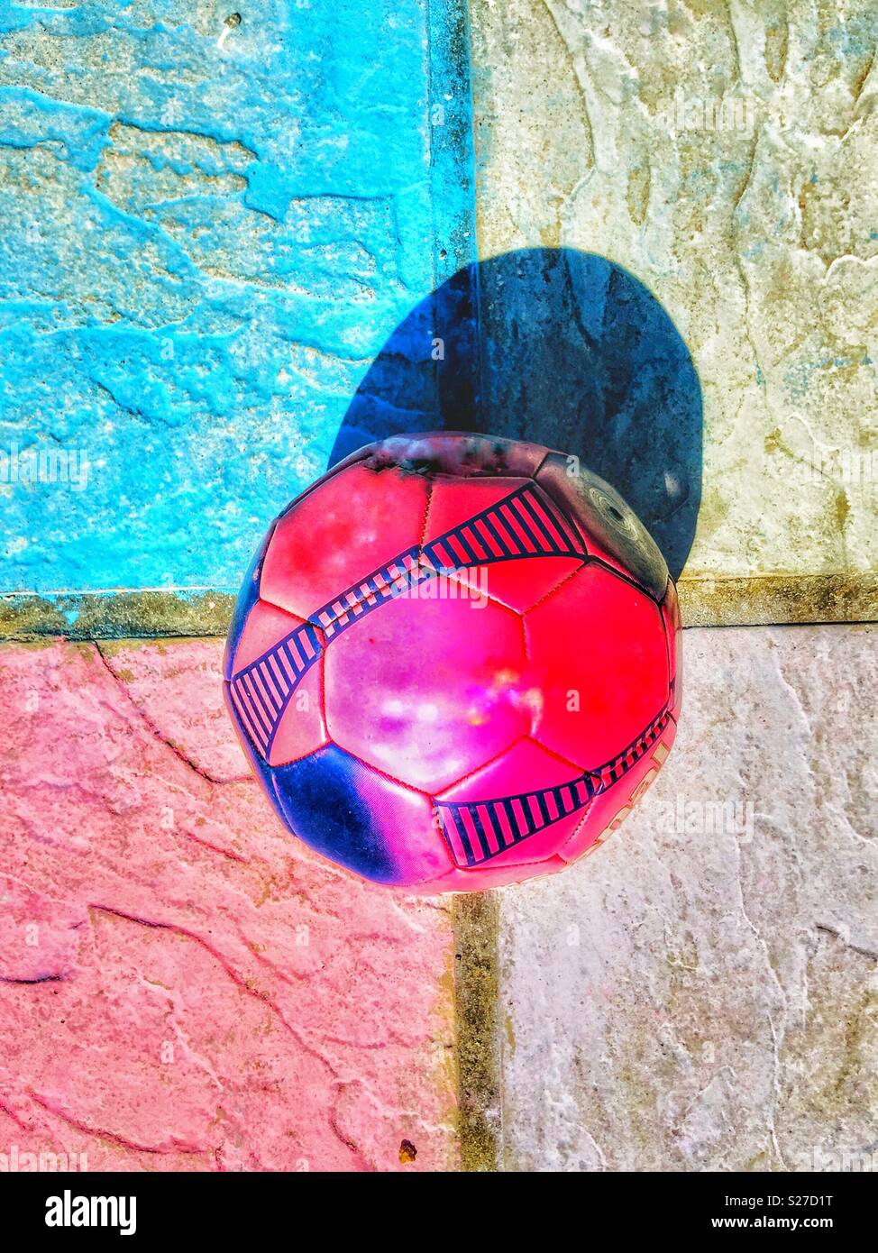 Football on colourful paving stones Stock Photo - Alamy