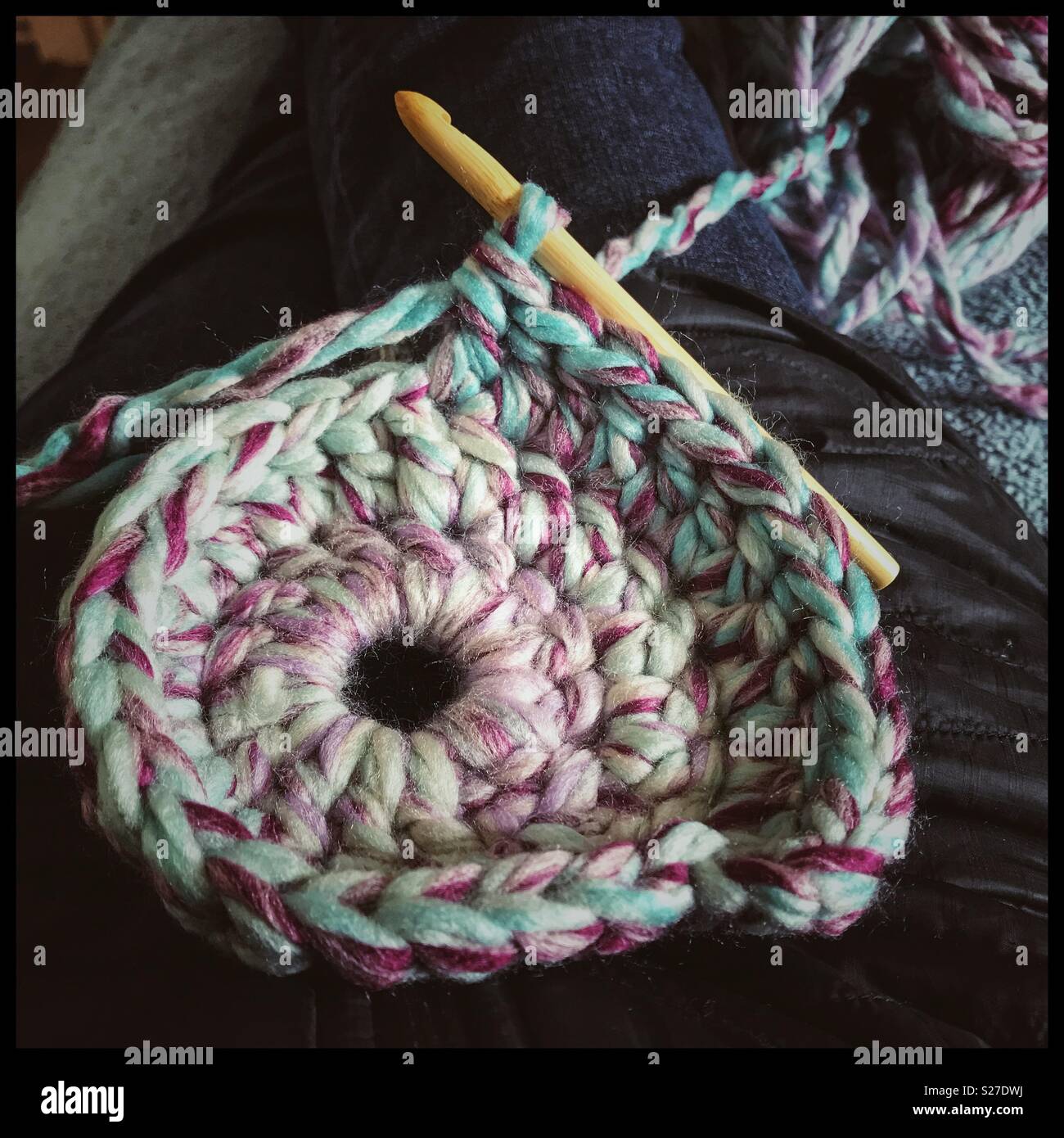 Thick wool and crochet needle Stock Photo - Alamy