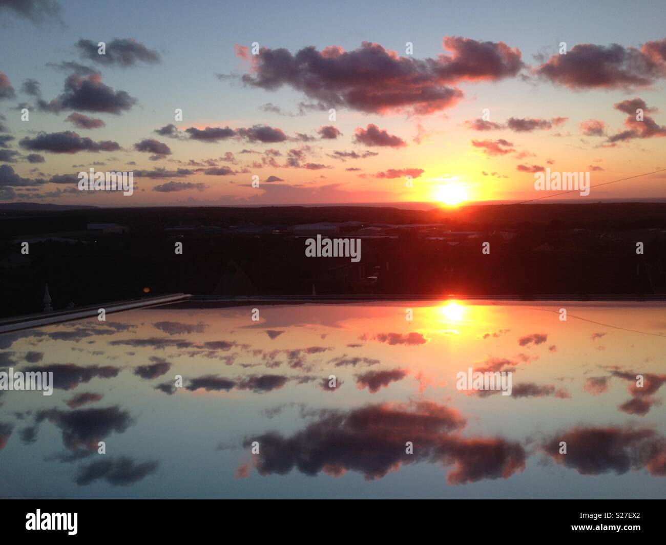 Sunset reflections in a window Stock Photo - Alamy