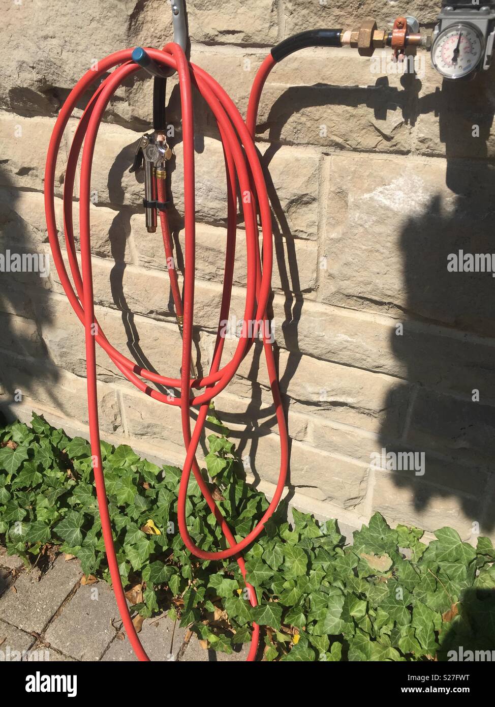 Air-pump and red hose Stock Photo - Alamy