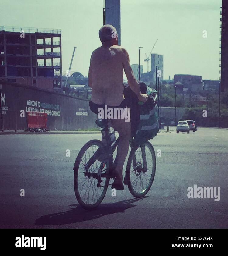 Man riding bike with bottom butt crack showing Stock Photo - Alamy