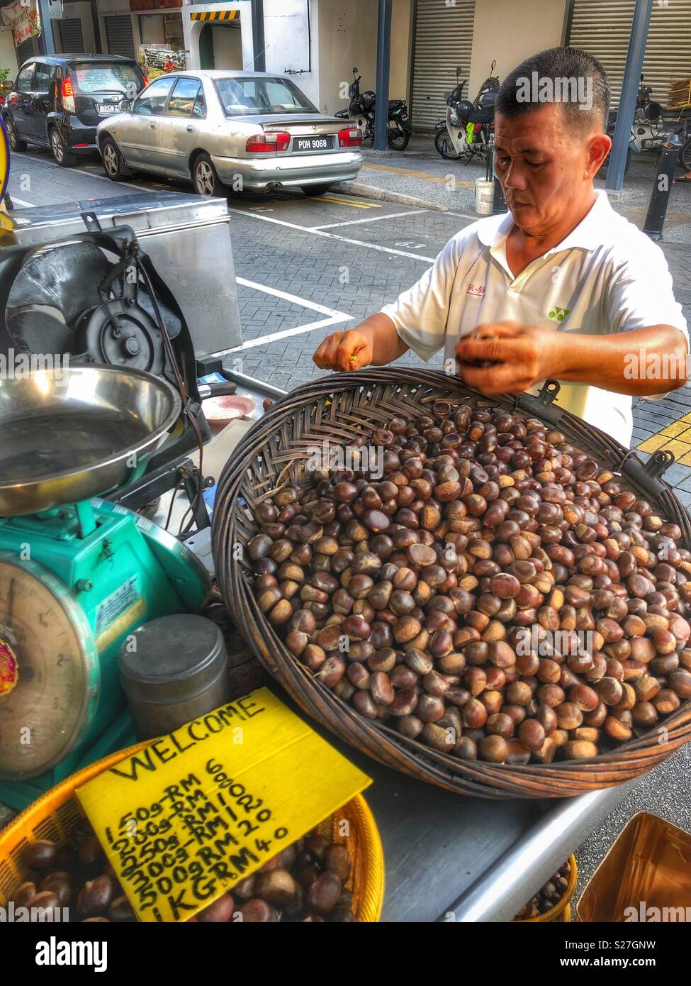 Street vendor selling roasted chestnuts in Penang, Malaysia Stock Photo ...