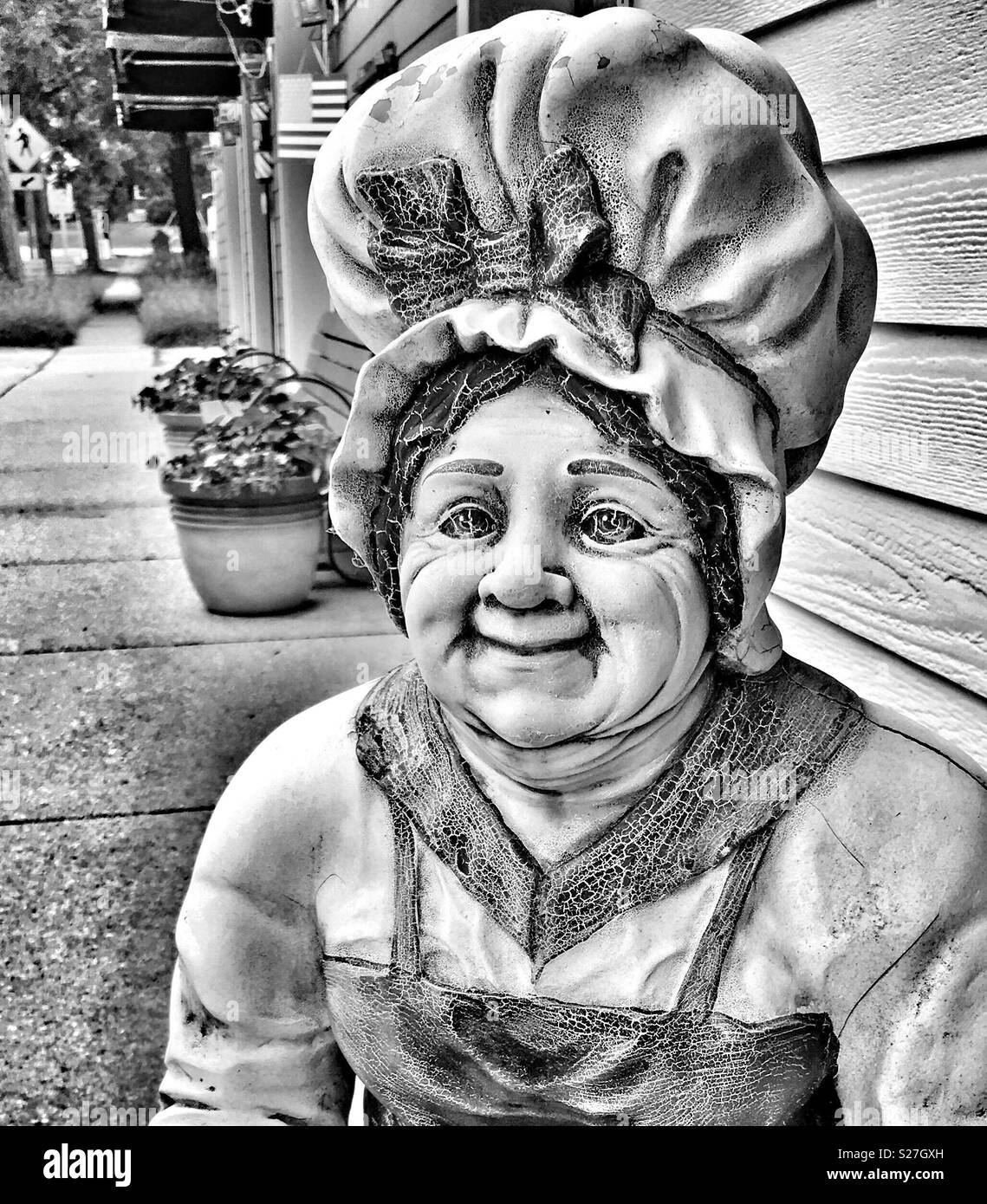 Statue of female baker in front of bakery on small town Main Street ...