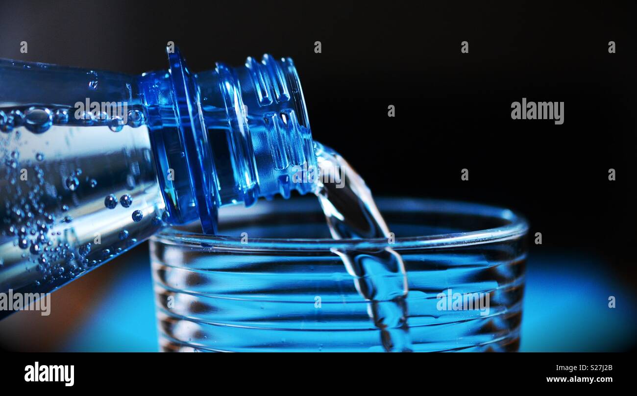 Water flowing into glass Stock Photo - Alamy