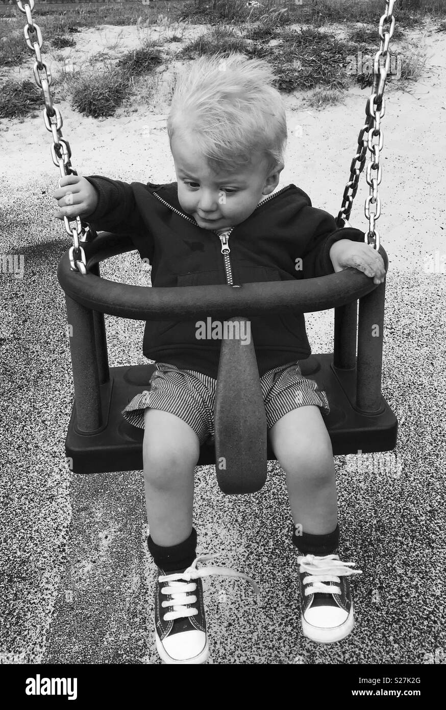Little boy on swing Stock Photo - Alamy