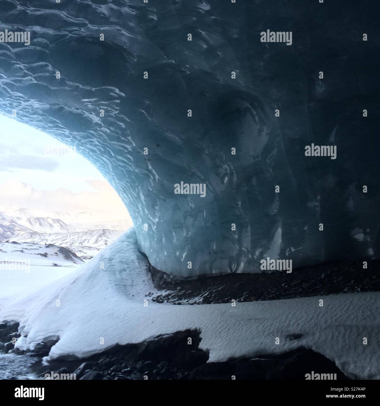 Curved blue ice wall at the entrance of an ice cave in Iceland Stock ...