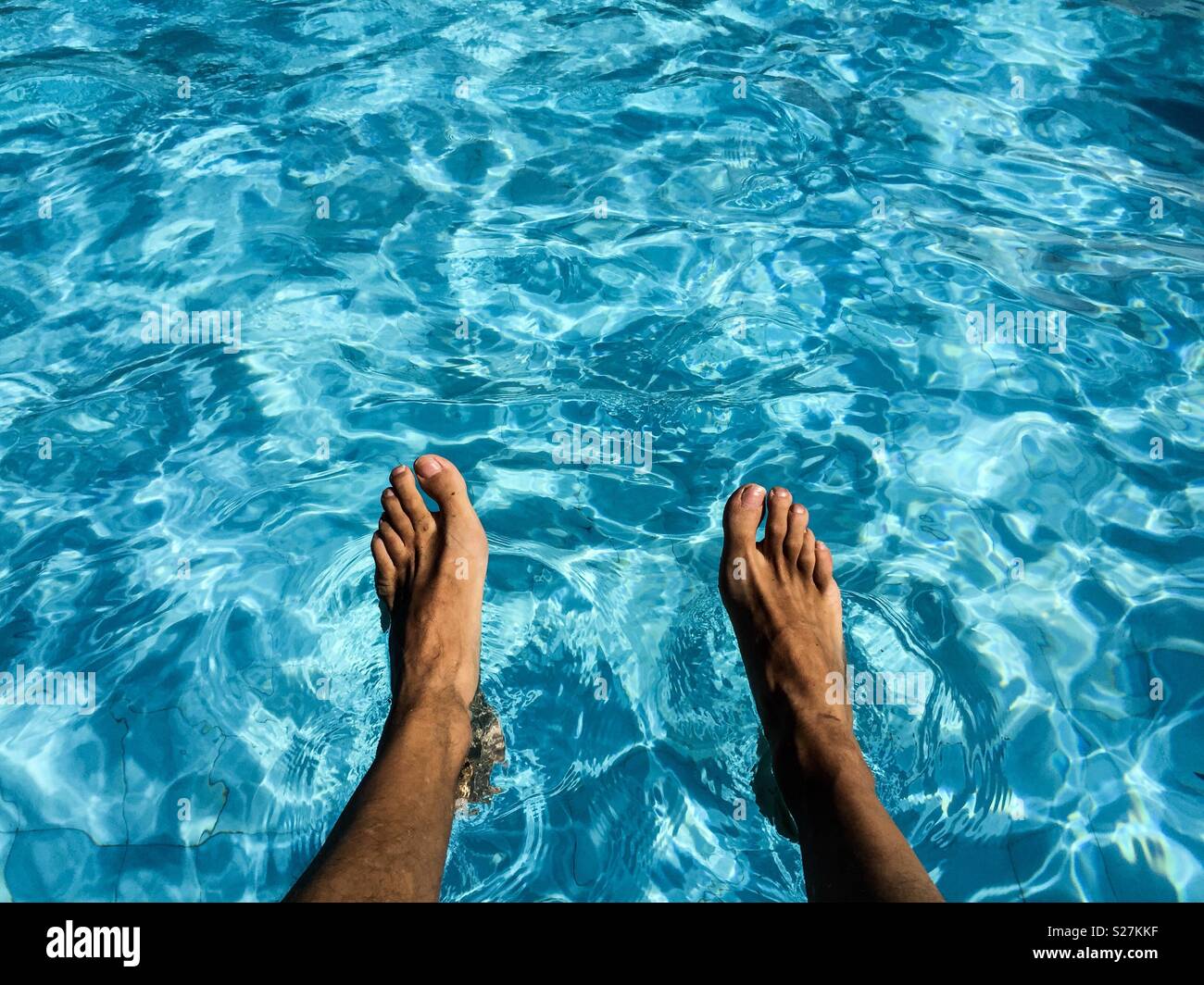 Refreshing feet on the pool Stock Photo - Alamy