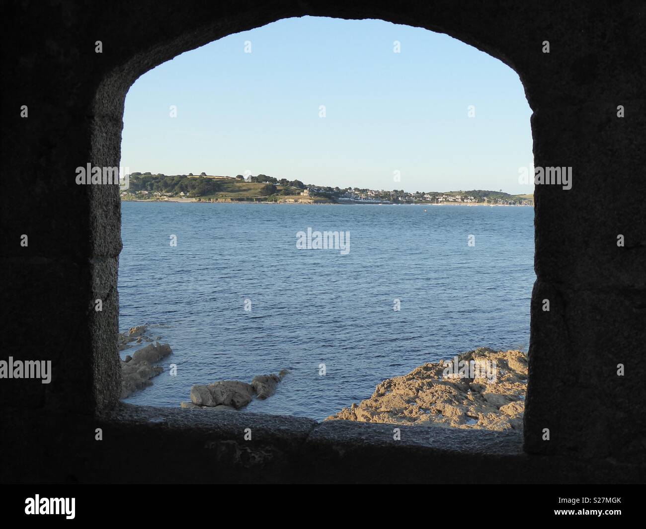 View through castle window over a cal sea Stock Photo - Alamy