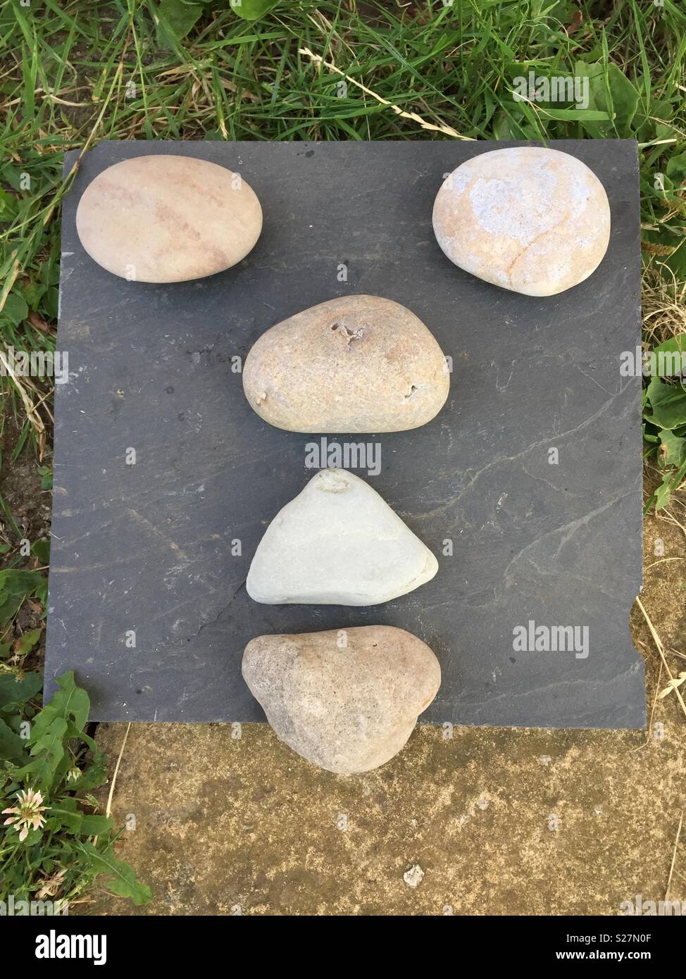 Pebble art face Stock Photo - Alamy