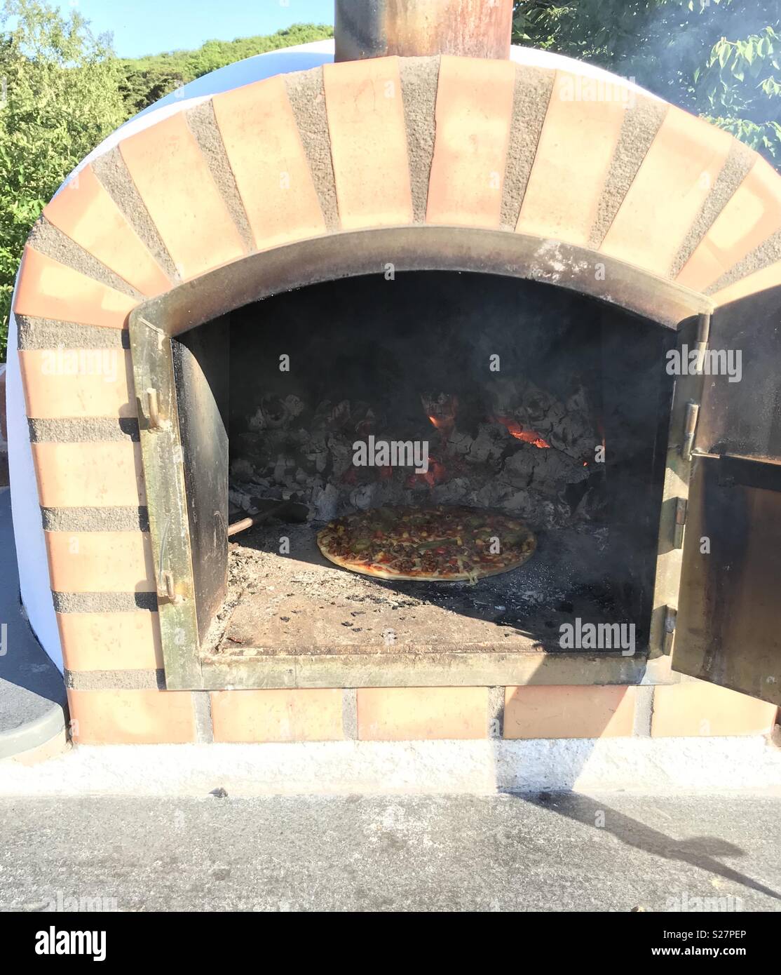Pizza cooking in a pizza oven Stock Photo - Alamy