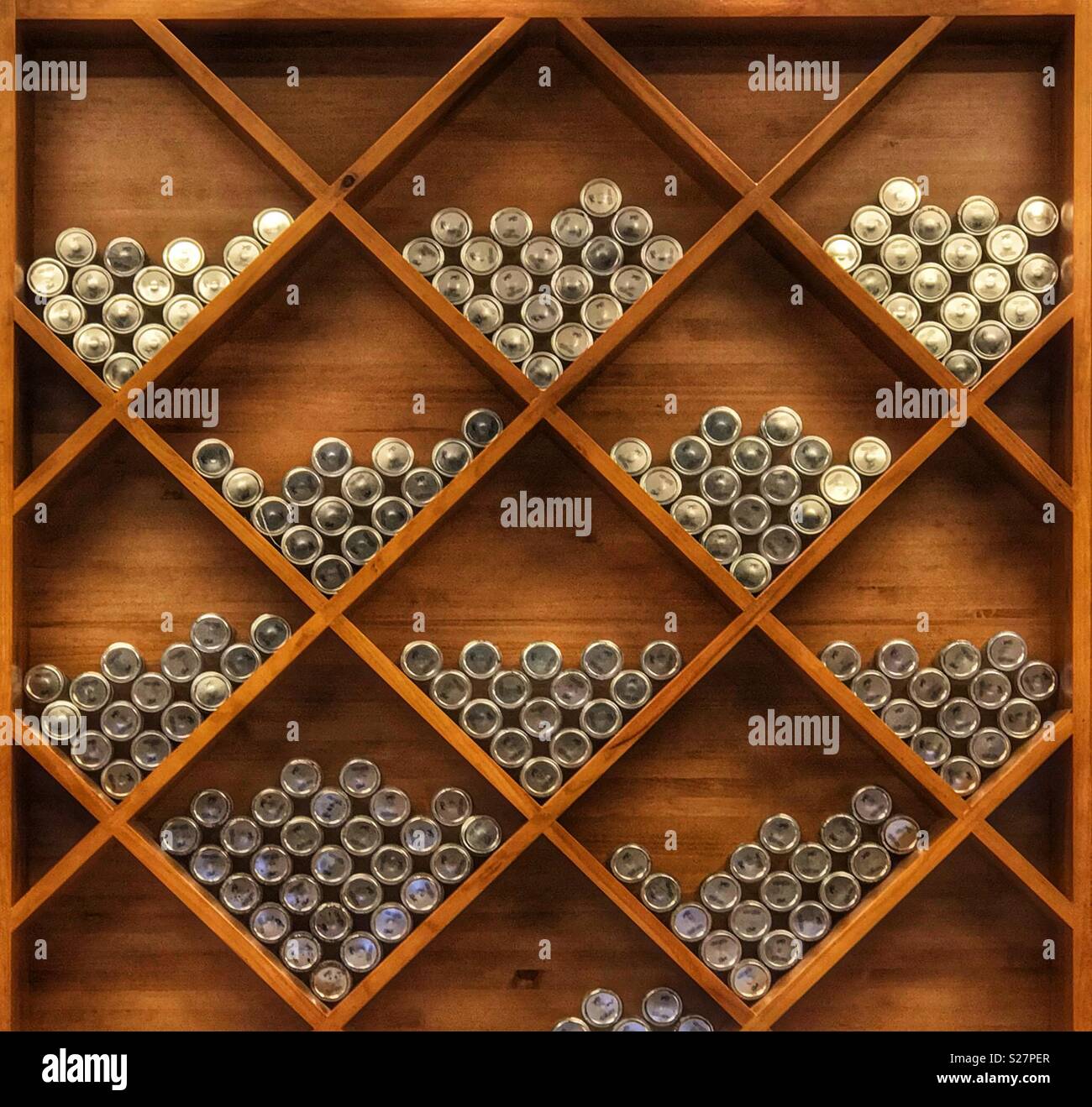 Wall-sized wooden spice rack with metal spice jars Stock Photo - Alamy