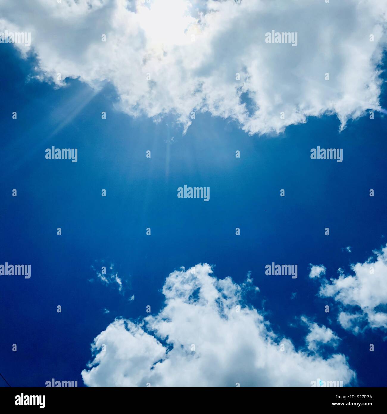 Blue sky, sunbeams and clouds Stock Photo - Alamy