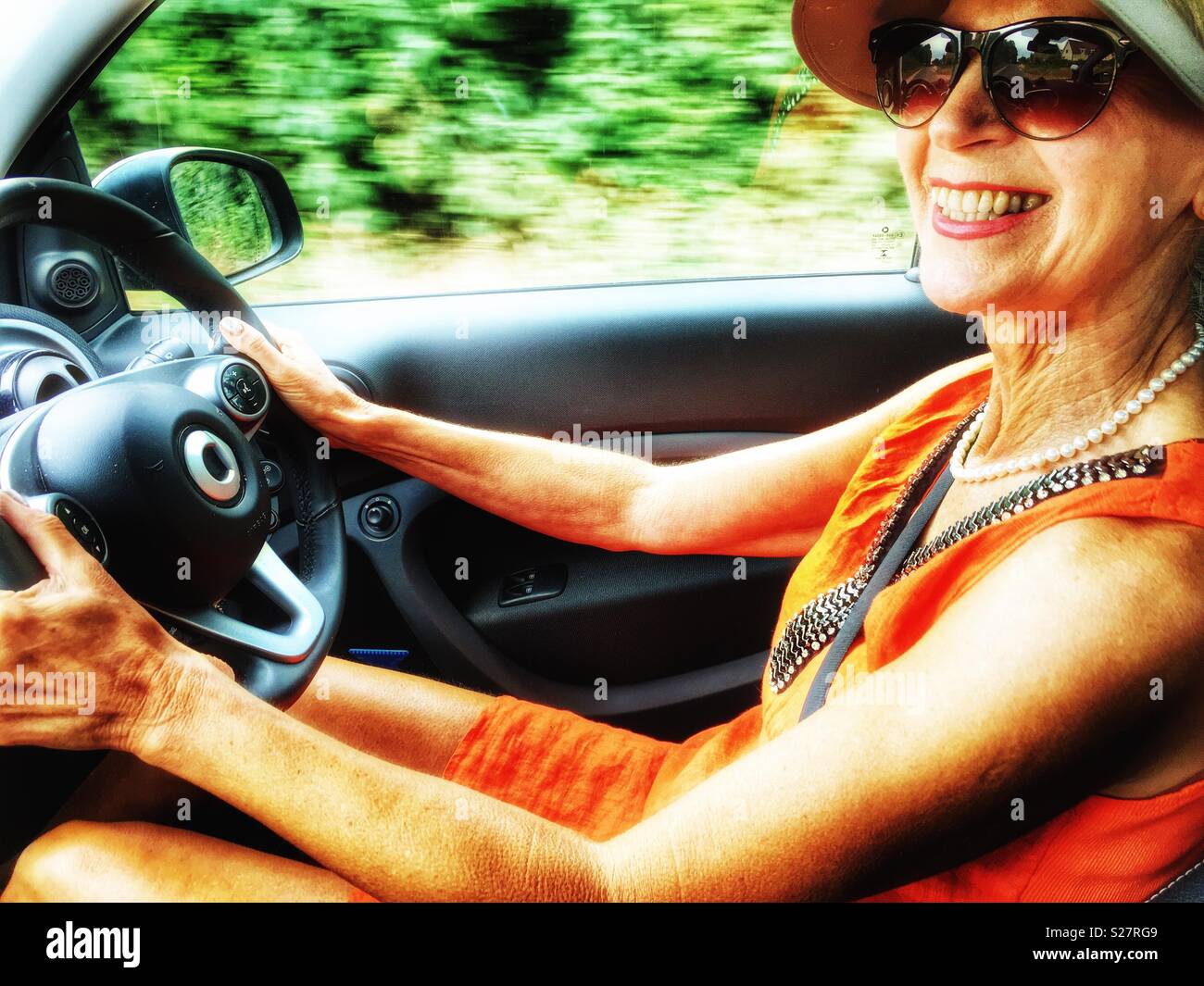 Woman having fun while driving Stock Photo - Alamy