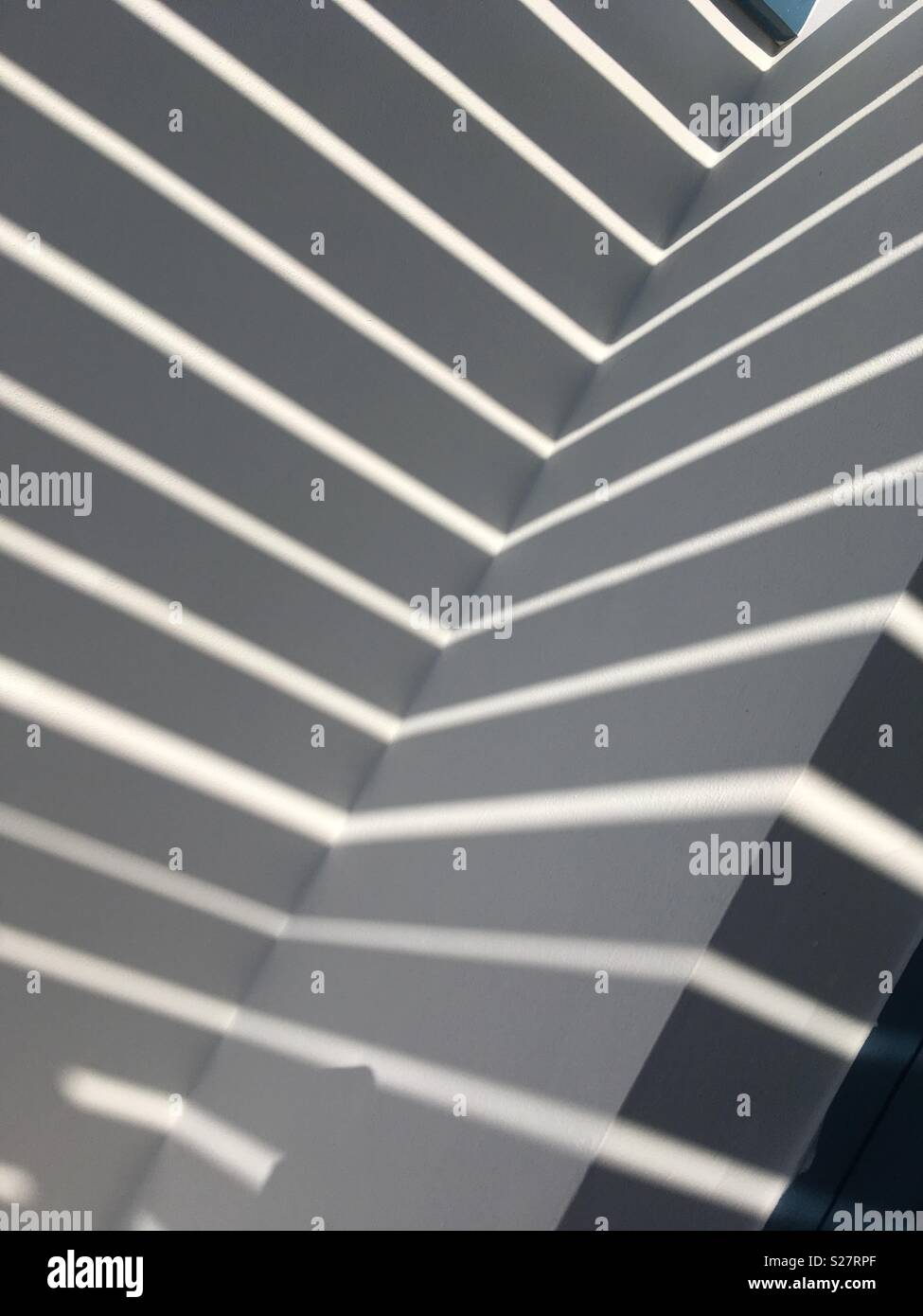 Angled shadows on a white wall Stock Photo - Alamy