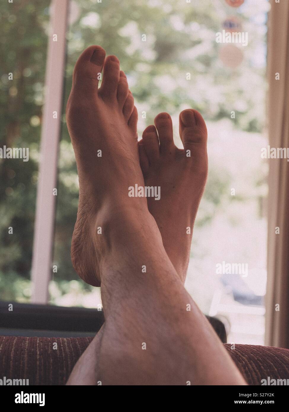 Male crossed legs Stock Photo - Alamy