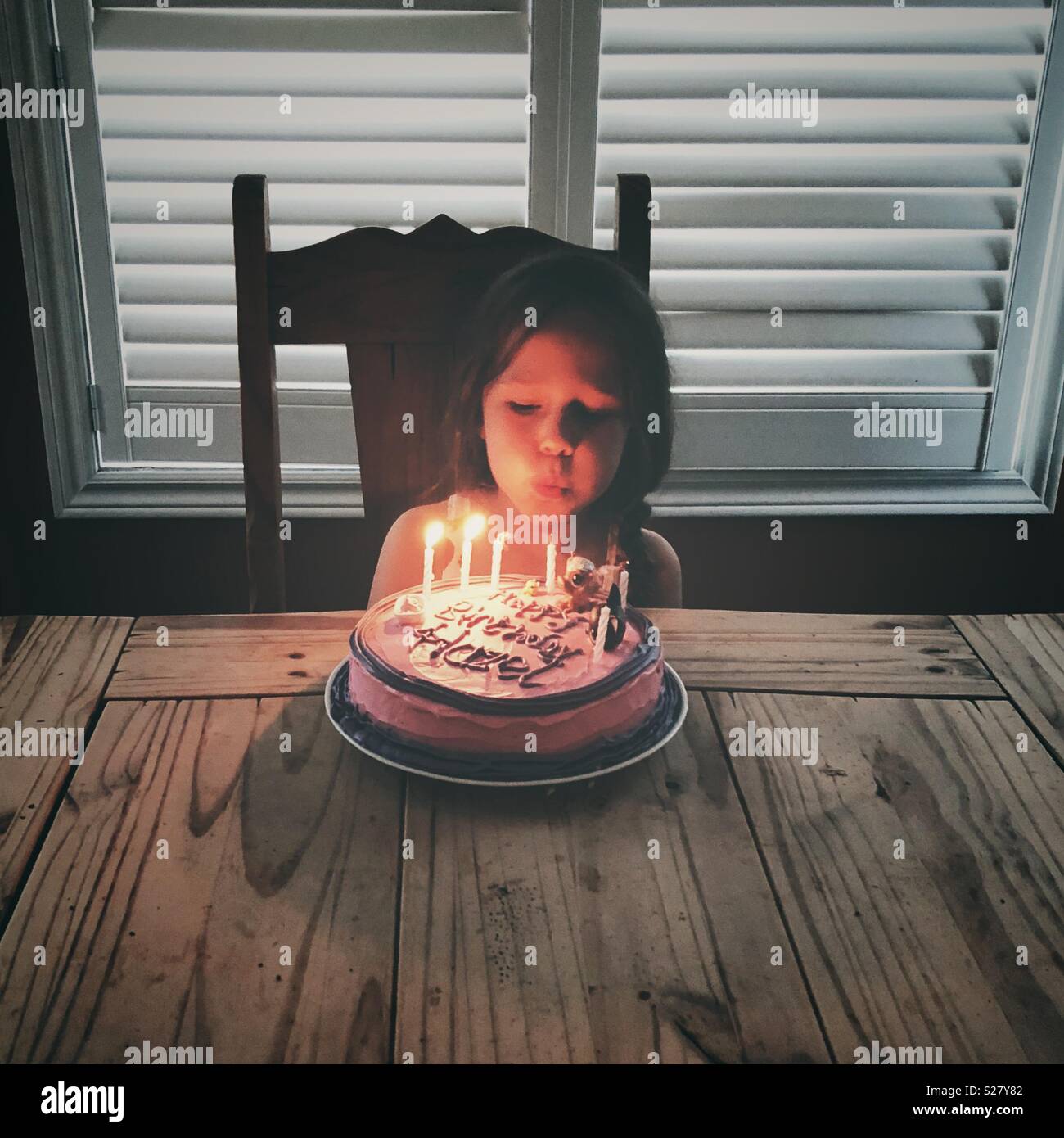 Birthday girl blowing out candles hi-res stock photography and images ...