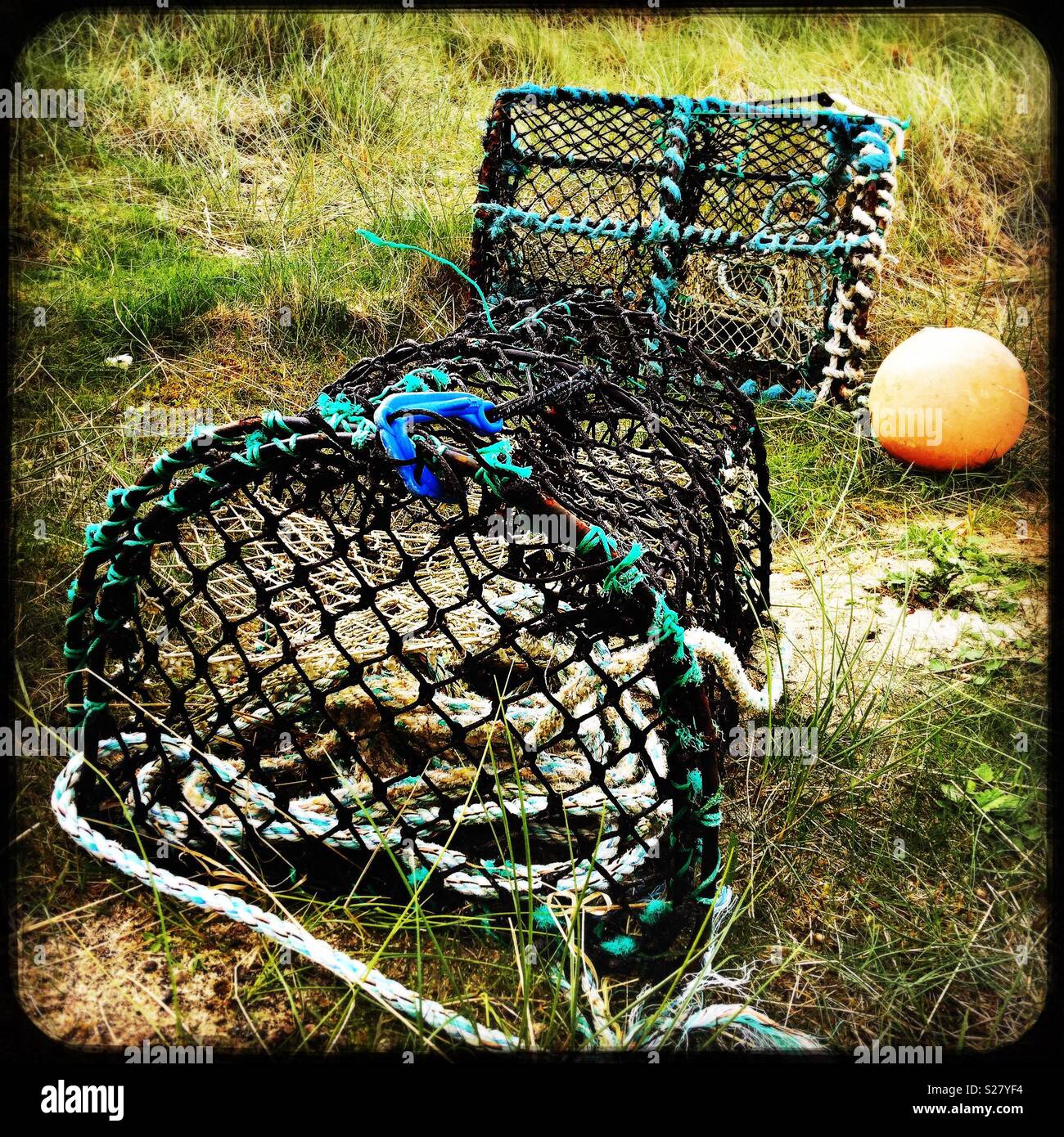 Lobster Pots and Float on Sandy Grass Stock Photo - Alamy