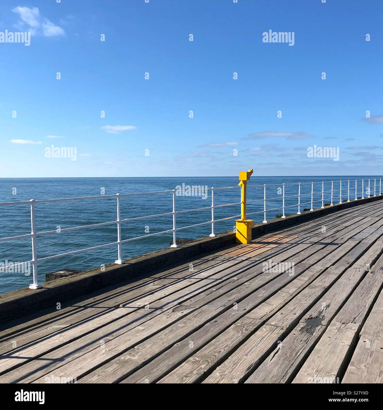 Slash of yellow on a pier Stock Photo - Alamy
