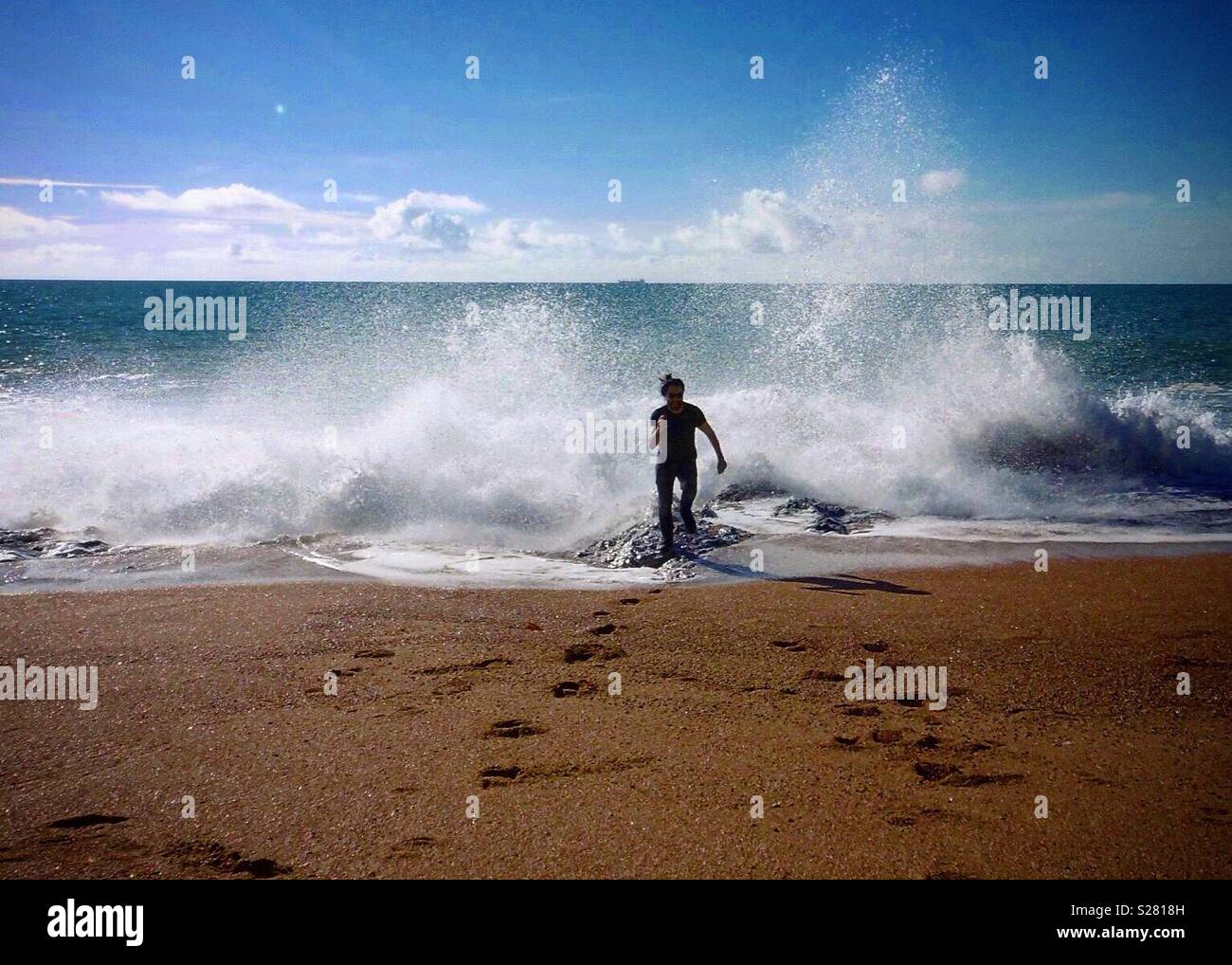 Lord as leaping from salt water droplets on Loe Bar in Cornwall Stock ...