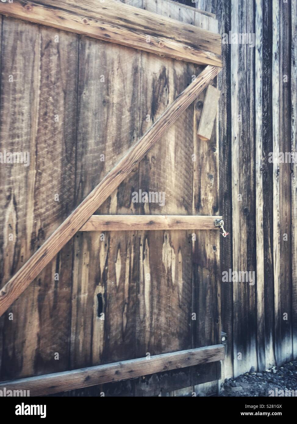 Rickety old antique rustic wooden barn door at a family farm plantation ...