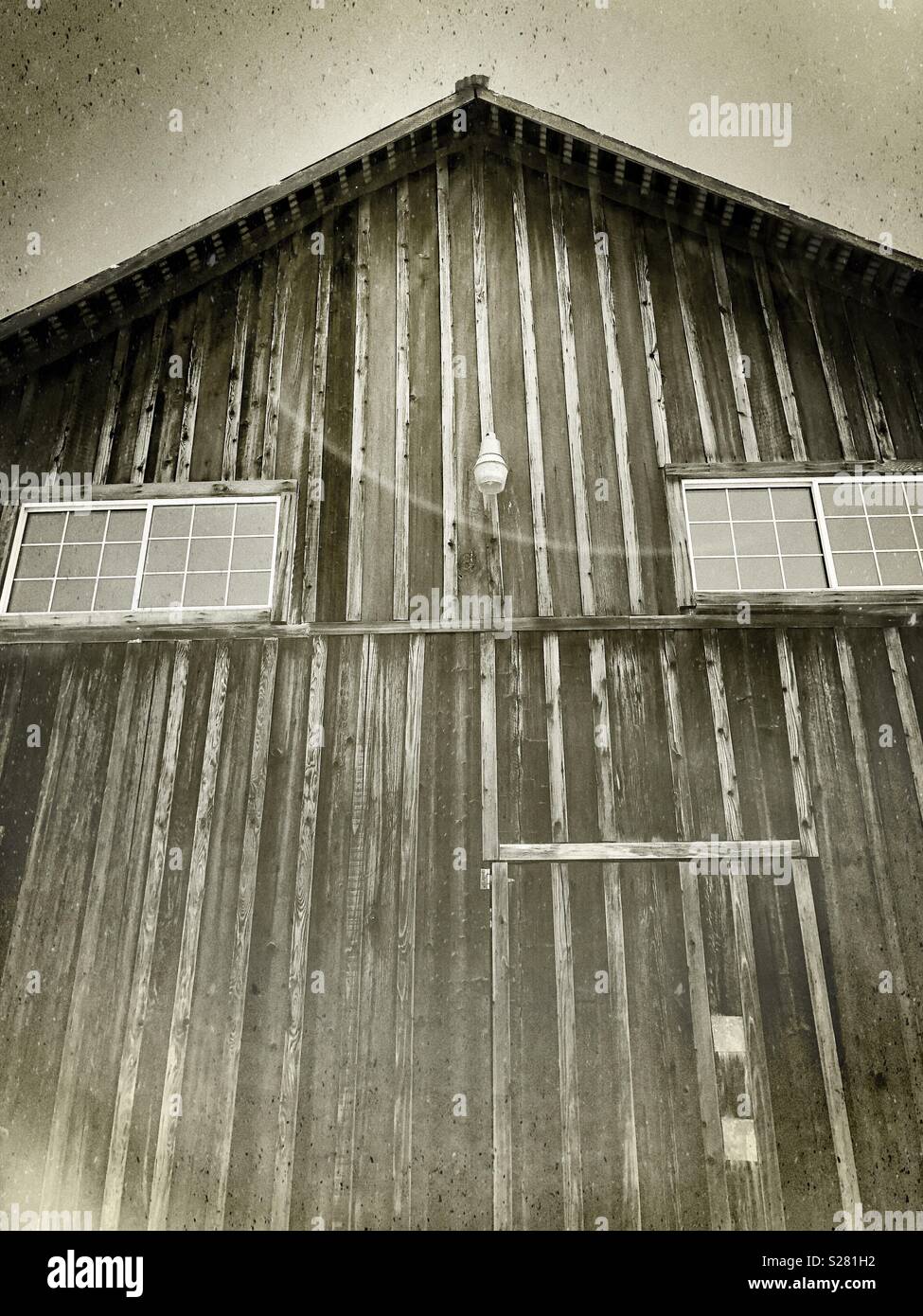 Old rustic wooden barn with modern windows in the rural backcountry of ...