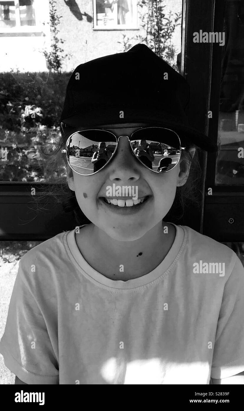 Girl in cap and mirrored glasses Stock Photo - Alamy