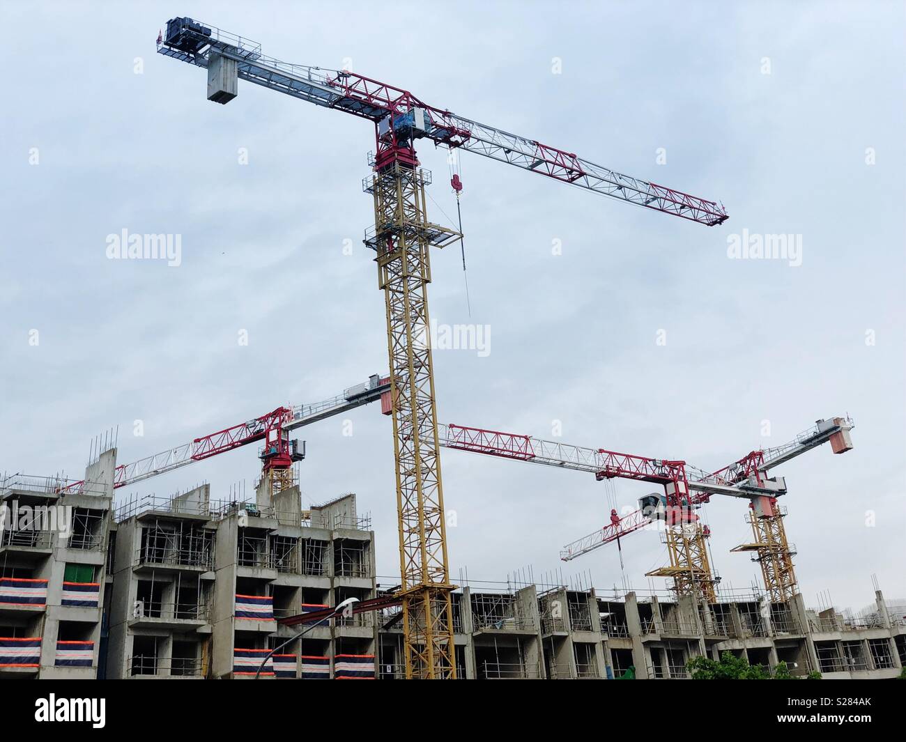Construction site with incomplete buildings and cranes hi-res stock ...