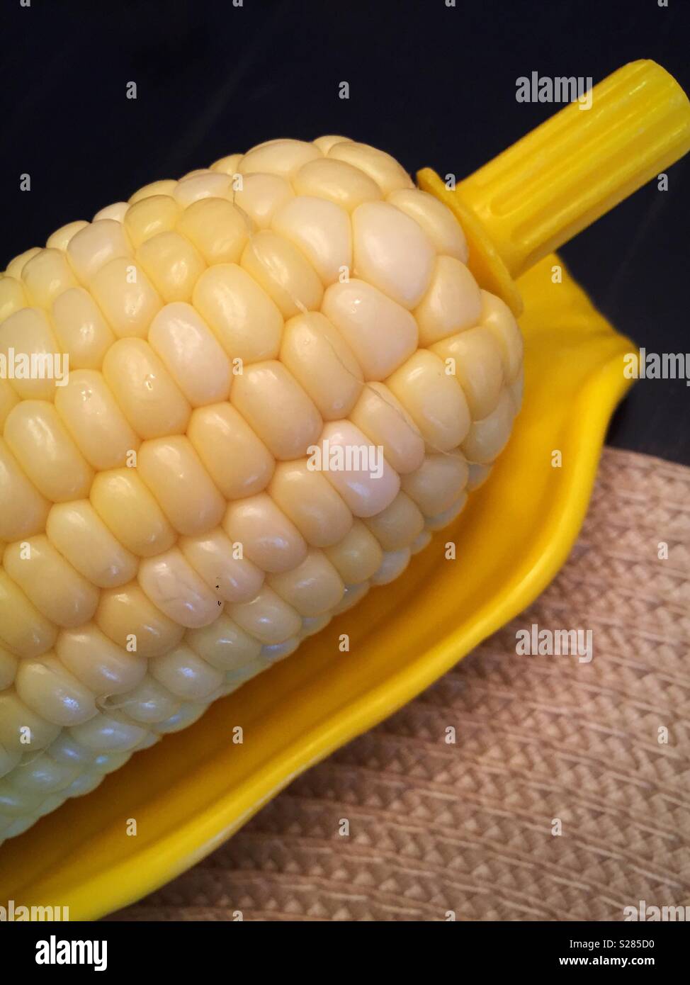 Fresh corn on the cob and cupholder on a special corn serving plate ...